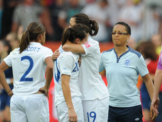 Hope Powell consoles her players after the World Cup defeat